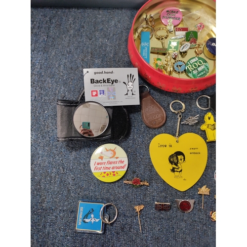 A job lot of pins, badges, key chains and fitness tracker