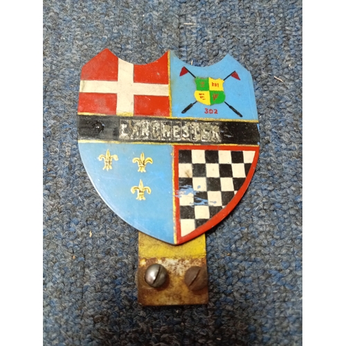 A vintage metal and enamel Lanchester car badge.
