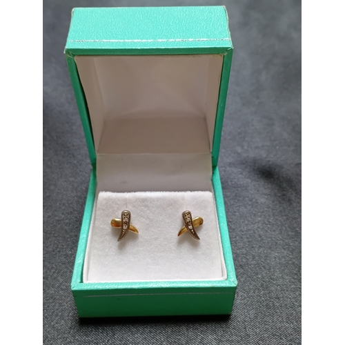 A set of stamped 375 DIA and 925 gold and silver cross earrings. No ...