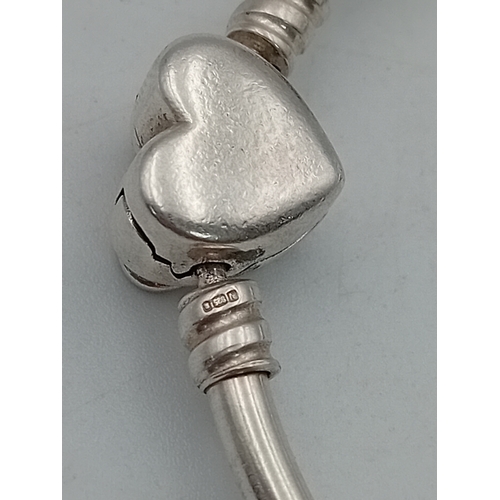 A stamped 925 silver charm bracelet with a Pandora chef charm.