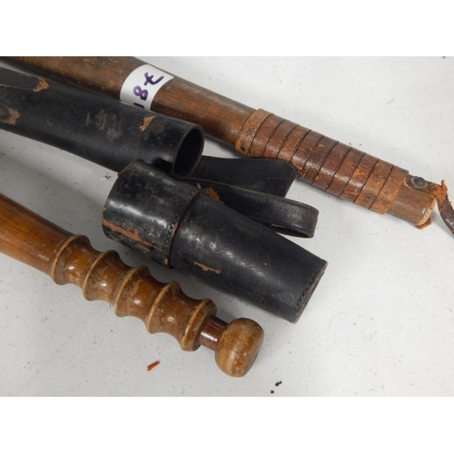 One leather cased police truncheon plus one other