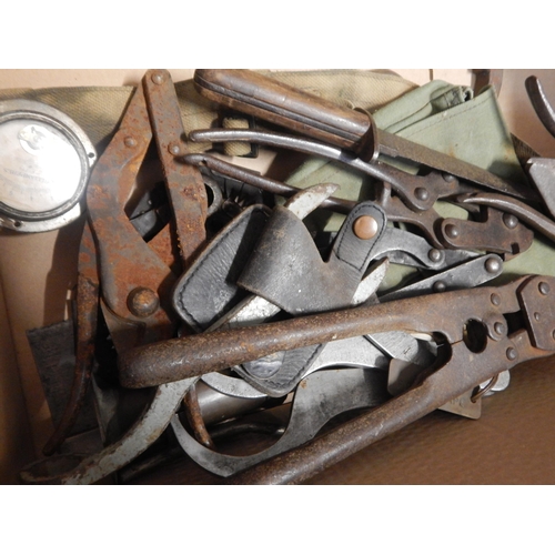 Box containing various military tools