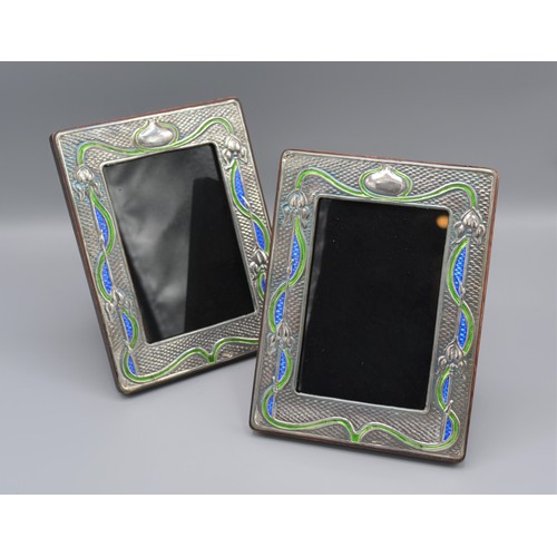 A pair of Sterling silver and enamel decorated photograph frames of ...