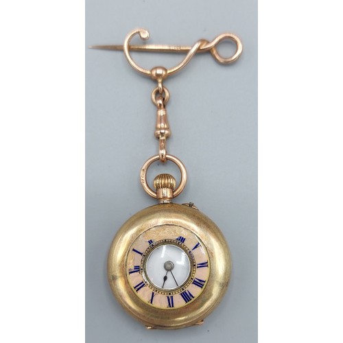 A 9ct gold fob watch with 9ct gold suspension pin, 22.4 gms including ...