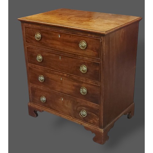 A 19th Century mahogany small four drawer chest with circular brass ...