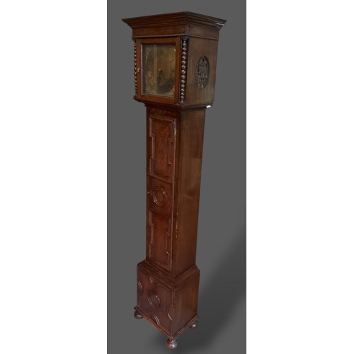 An early 20th Century oak longcase clock, the arched hood above a ...