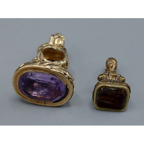 Two stone set fobs together with two pendant lockets