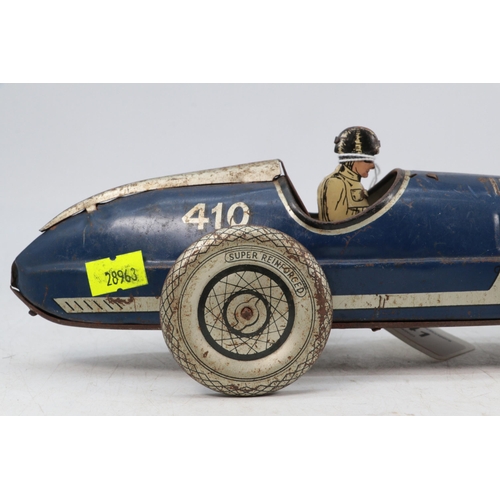 A vintage tin plate clockwork racing car