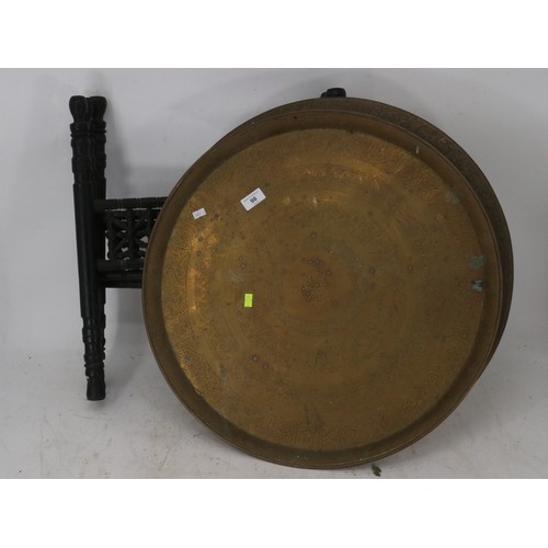 A brass tiffin table on ebonised base, together with one other. Tops ...