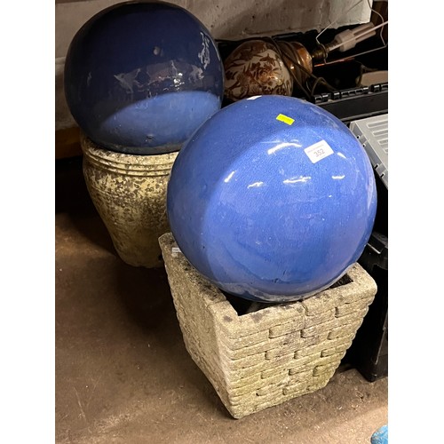 Two blue glaze garden spheres together with two garden pots.