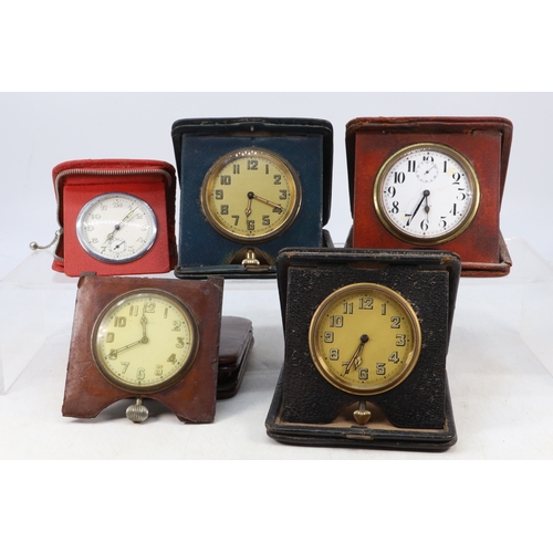 Five leather cased vintage travel clocks
