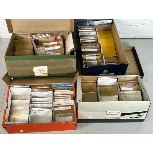 Four shoes boxes of sorted packets of World stamps