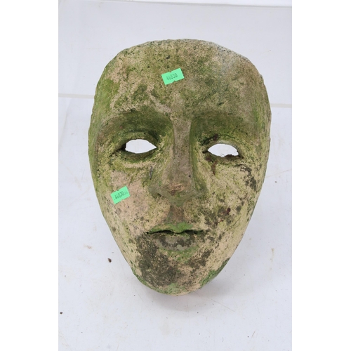 A garden face plaque