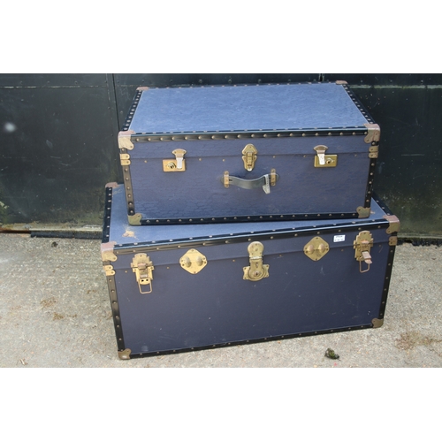 Two large travel trunks
