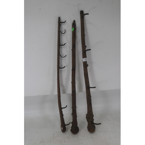 Three rustic (French?) ham / pan hooks.