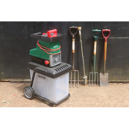 Qualcast garden shredder together with two forks and a spade and a hose ...