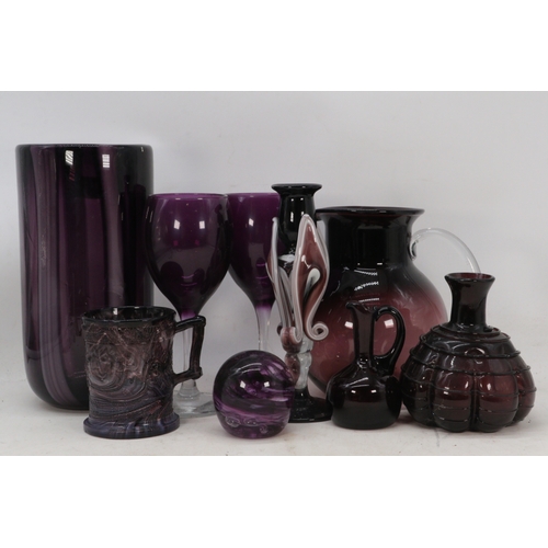 A selection of decorative purple glassware including candlestick, jug ...