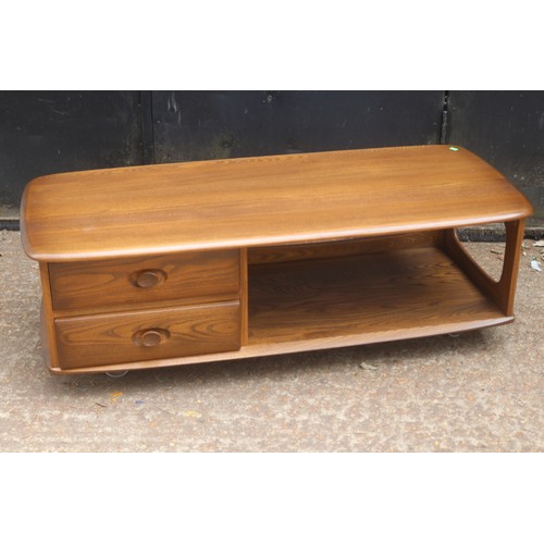 Ercol Minerva coffee table on castors. Measures approx. 124w x 54d x 41cmh
