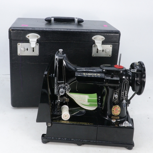 A cased singer 222K sewing machine with foot pedal, and accessories