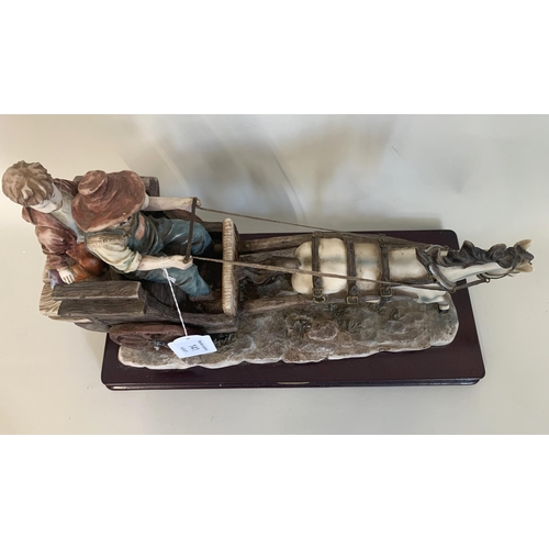 A large Juliana Collection horse and cart with man driving and boy ...