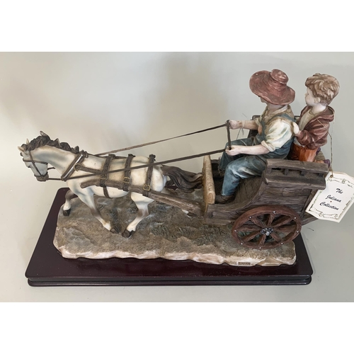 A large Juliana Collection horse and cart with man driving and boy ...