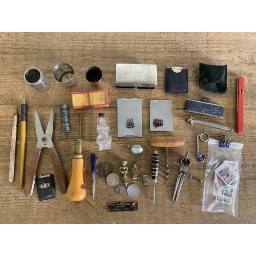 A small box with items of interest including a cigar cutter, needle ...