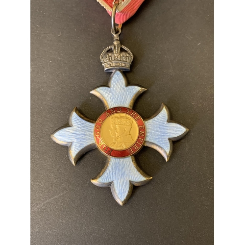 A vintage CBE (Commander of the British Empire) medallion neck badge on ...