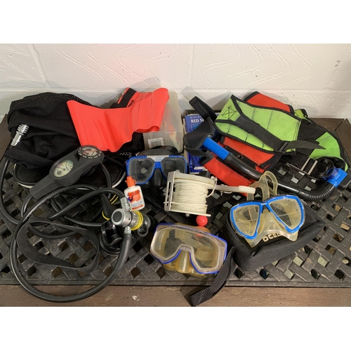 A vintage Oceanic Alpha regulator, three sets of masks, a shot line ...