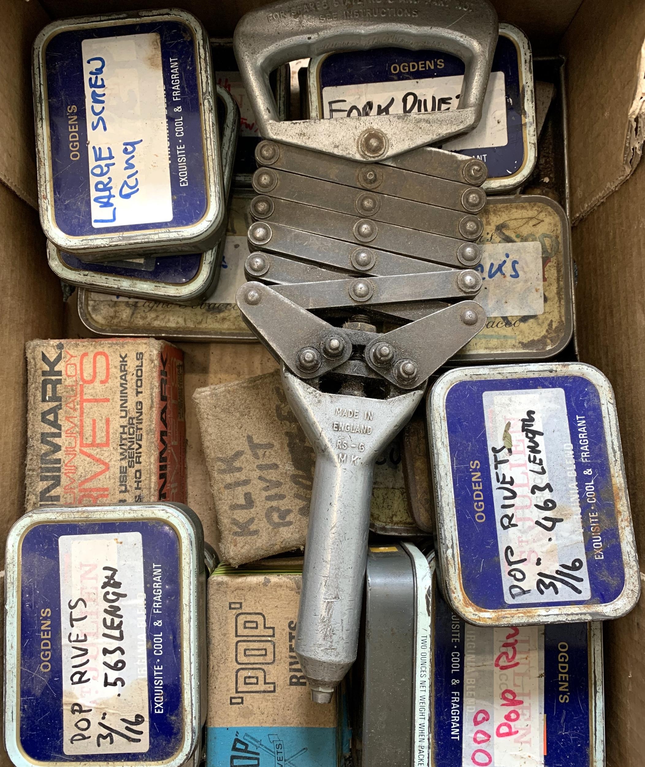 A vintage Lazy Tong pop rivet gun with parts and a large amount of pop ...