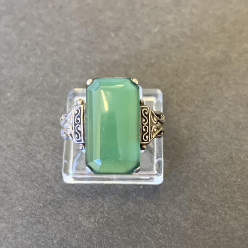 A sterling silver and green stone set ring in original box, approx ...