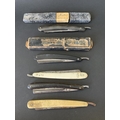 Five antique cut throat razors, two boxed, two hand engraved