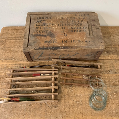 Two vintage line winders with floats in an unassociated wooden box