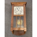 A vintage wood cased key wind wall clock with pendulum and key, approx ...