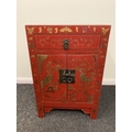 A small vintage Oriental cupboard, wood carcass with red background and ...