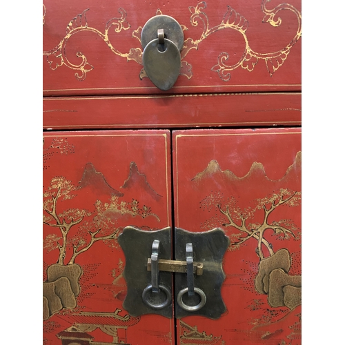 A small vintage Oriental cupboard, wood carcass with red background and ...