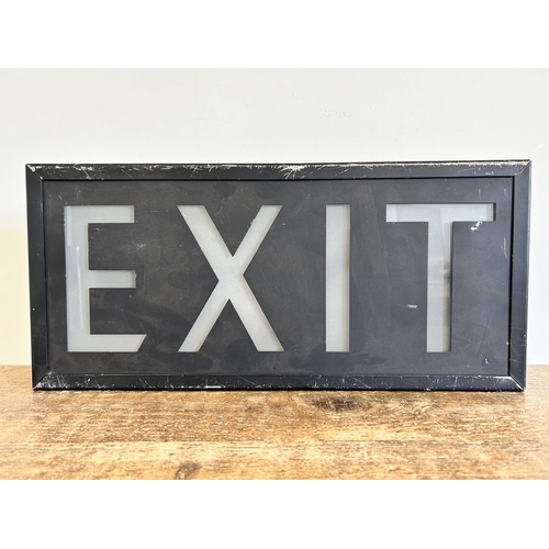 A vintage former electric black finish 'EXIT' sign, 16 1/4" long (signs ...