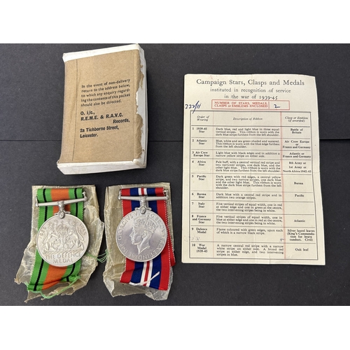 A boxed pair of WW2 medals with award slip