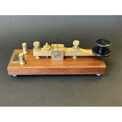 A boxed 'Kent' straight morse key of brass construction with cables ...