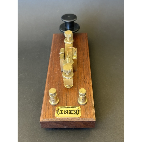 A boxed 'Kent' straight morse key of brass construction with cables ...