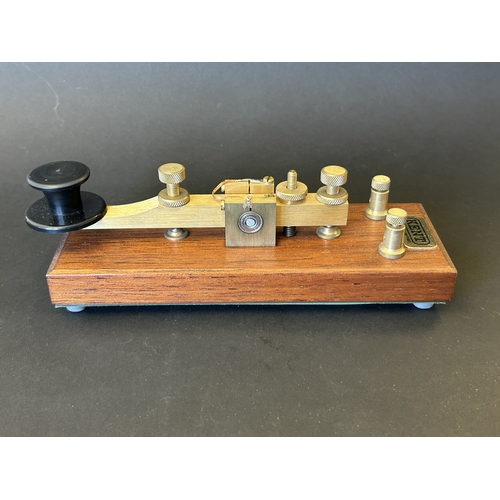A boxed 'Kent' straight morse key of brass construction with cables ...