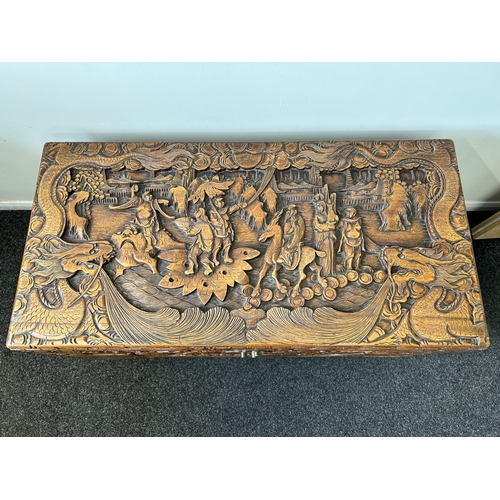 A vintage large carved Chinese style camphor wood chest decorated with ...