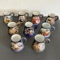 Nine Great Yarmouth pottery character mugs to include HMS Victory ...