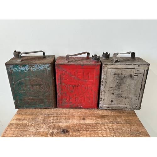 Three vintage petrol cans to include Esso and Shell