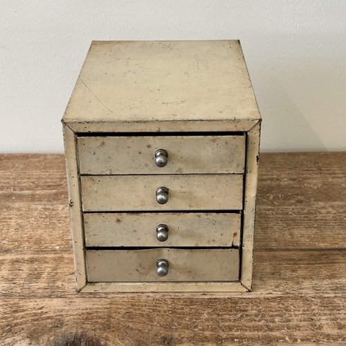 A vintage very small set of metal drawers with label at the back for ...