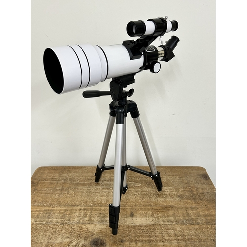 A Model 70300 Ground Astronomical telescope with stand and accessories