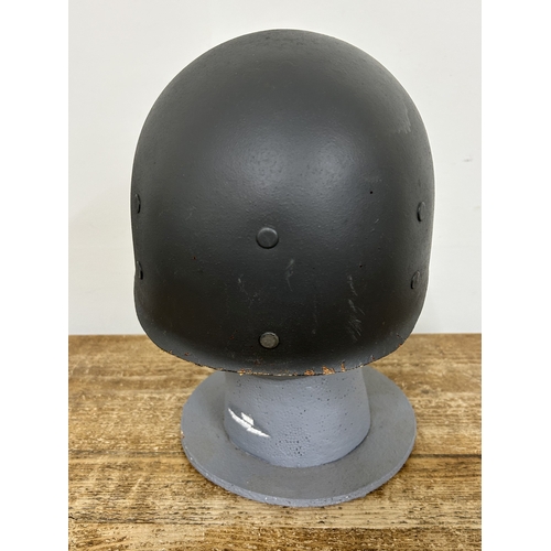 A vintage COPY of a U.S. M1 combat helmet in olive green, this comes ...
