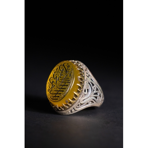 An Islamic Silver Ring with Inscribed Yellow Agate. A silver ring ...