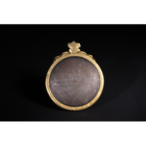 A Tibetan Buddhist Gilt Copper Amulet with Inscribed Mandala. A ...