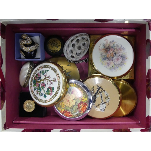 A box of old compacts, two rings and a carved stone egg.