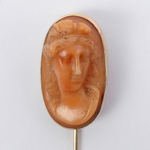 14ct gold and carved coral stick pin, 5 grams, 75mm long, 26mm x 15mm.